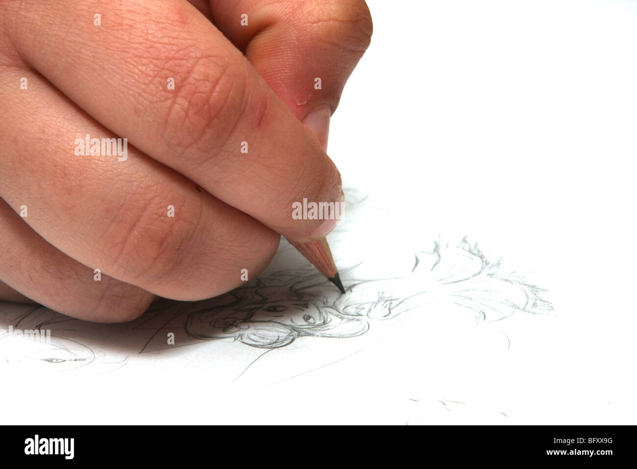 Cutout of a man's hand as it draws a drawing with a pencil on white ...