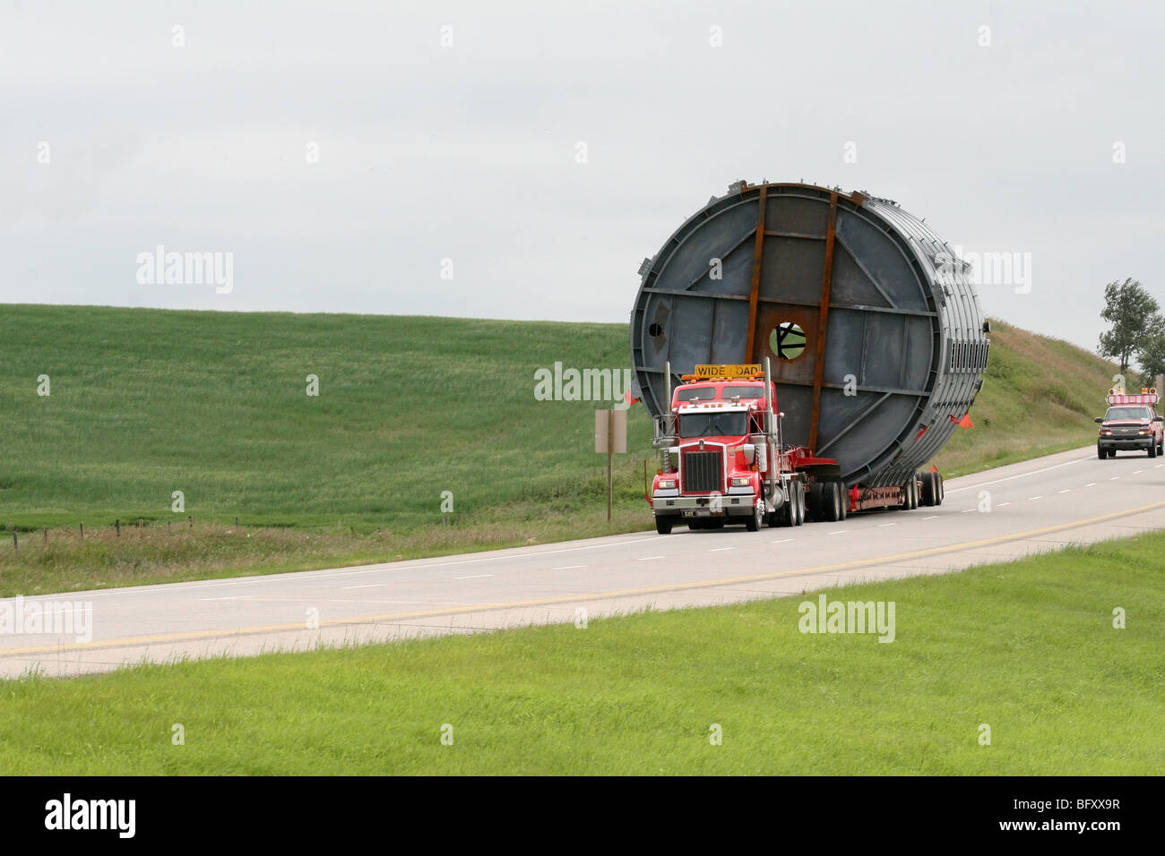 big truck moving a large tank Stock Photo - Alamy