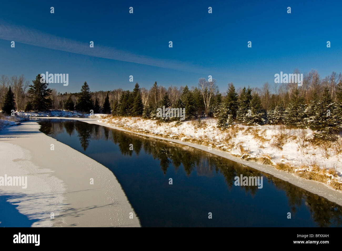Open water channel in Junction Creek with tree reflections, Greater ...