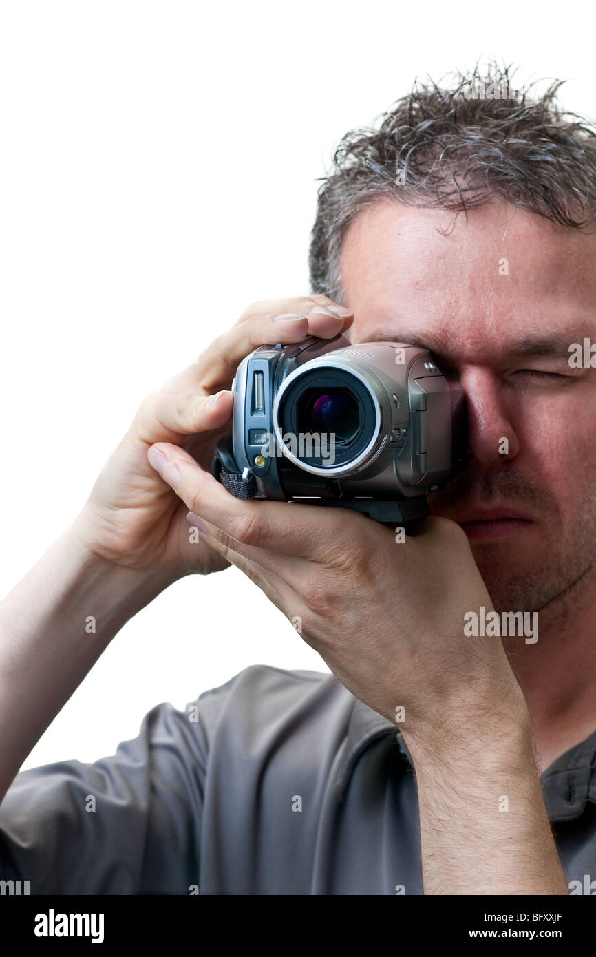 A man shooting with a video camera, isolated on white Stock Photo - Alamy