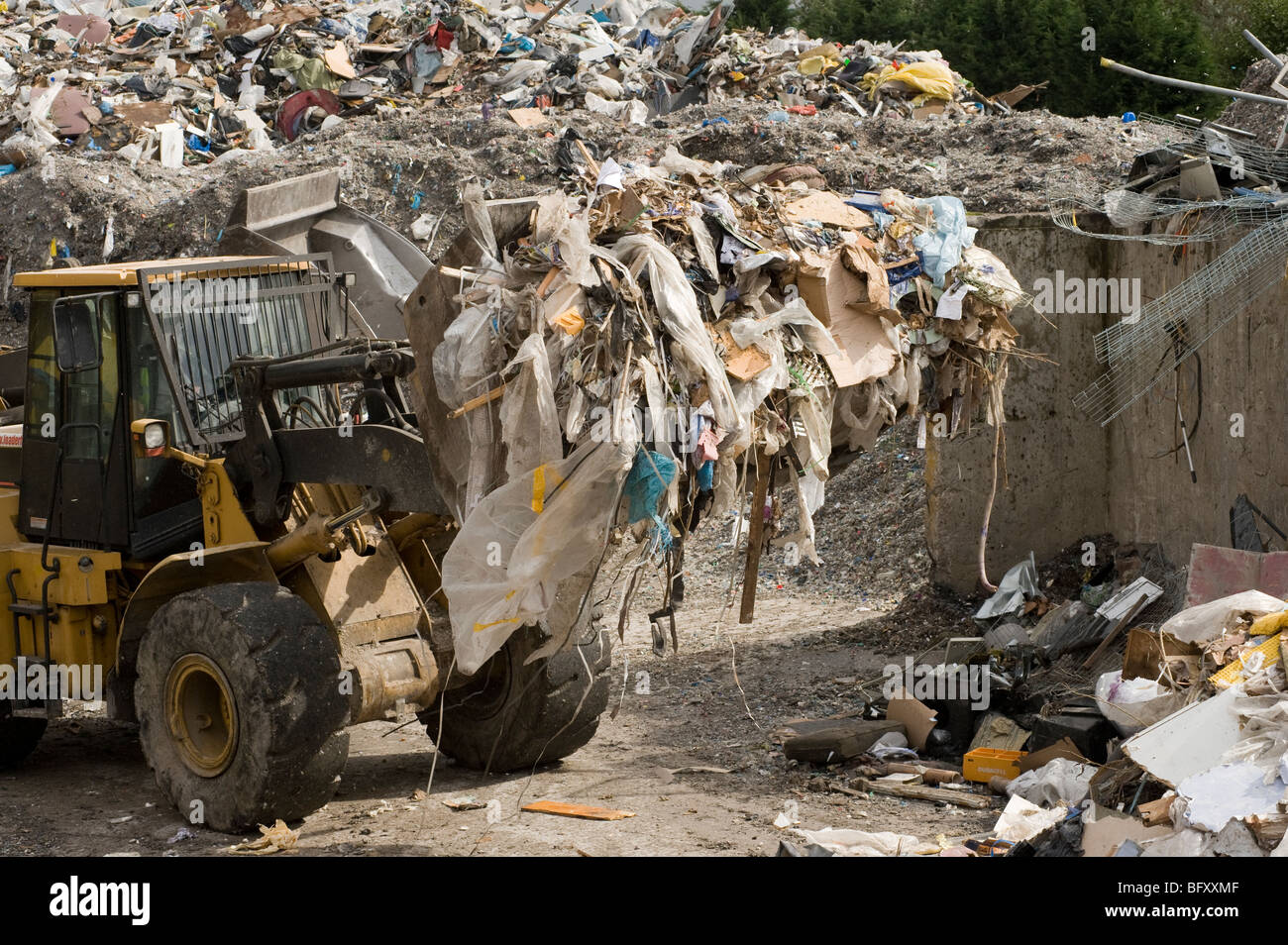 Excavator working at a materials recycling facility in England Stock ...