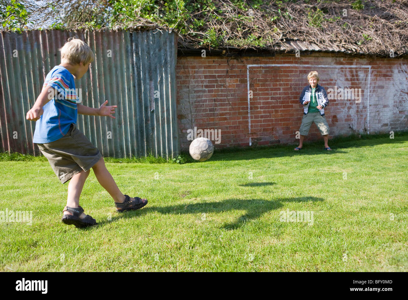 Child footballer shooting at goal Stock Photo - Alamy
