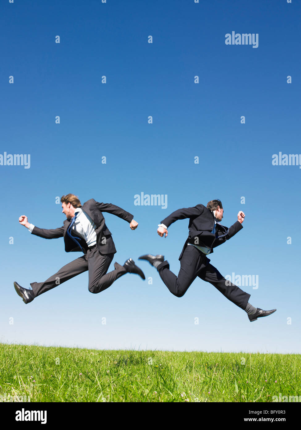 Man suit jumping blue hi-res stock photography and images - Alamy