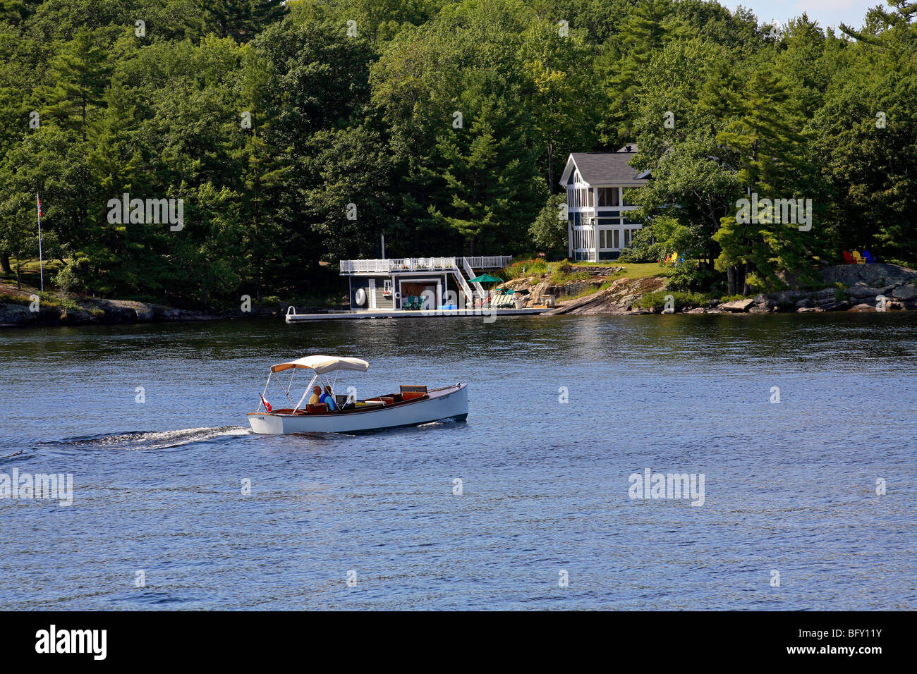 Family boating fun on lake in Cottage Country in the Summer on Lake ...