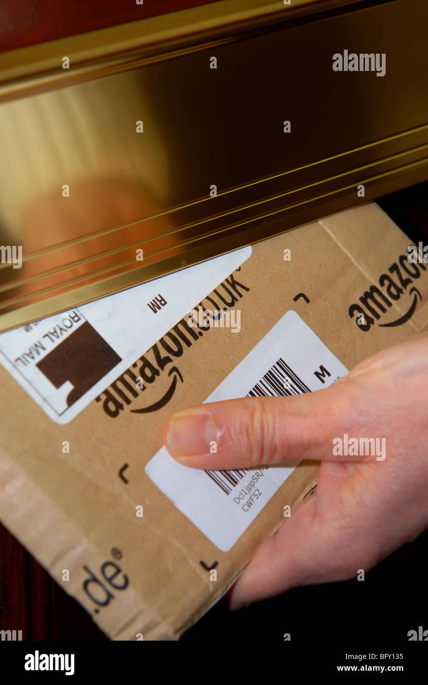 generic shot of an Amazon parcel being received to illustrate internet ...