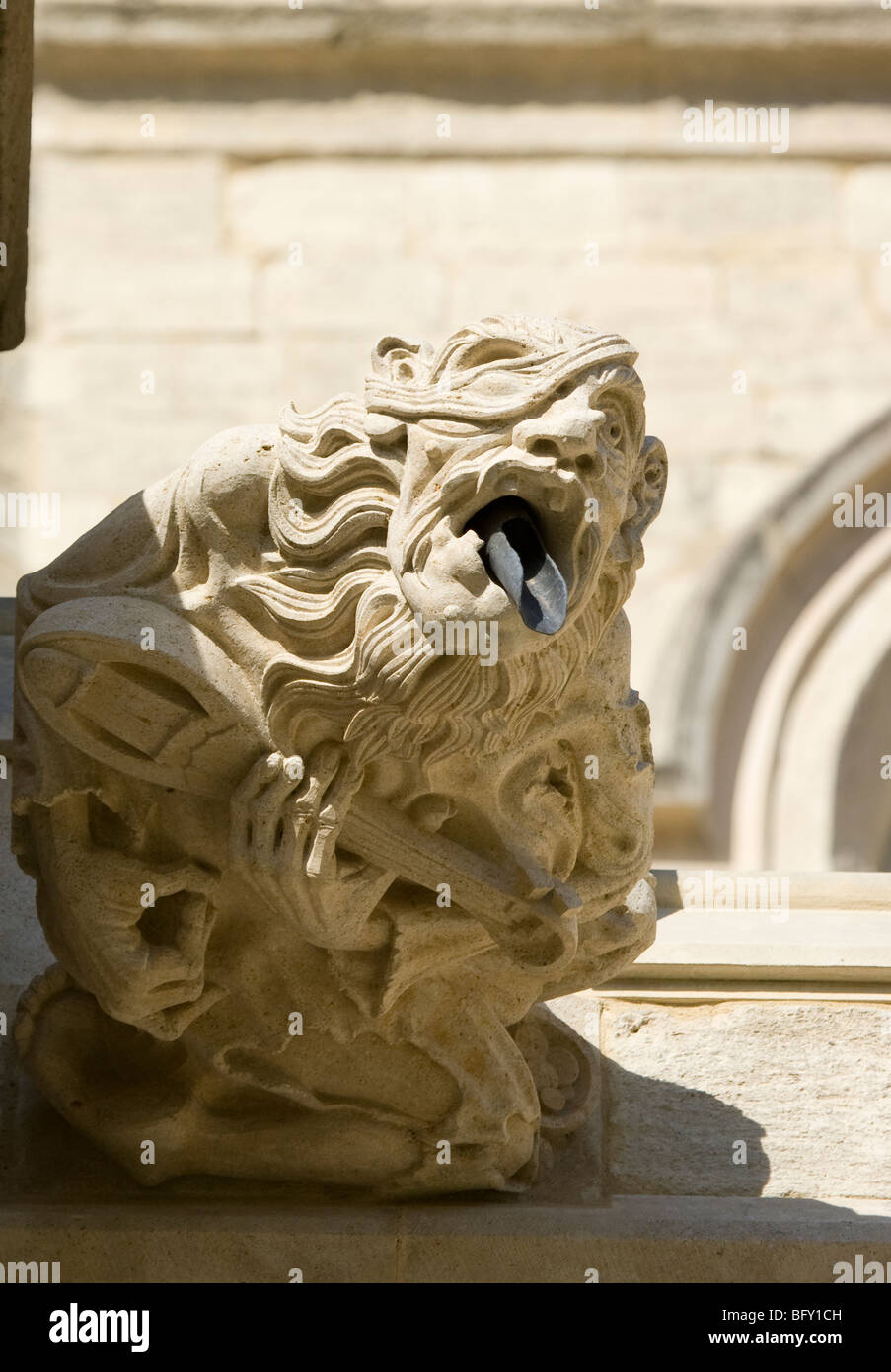 Ugly gargoyle in the form of a pirate with a patch over his eye playing ...