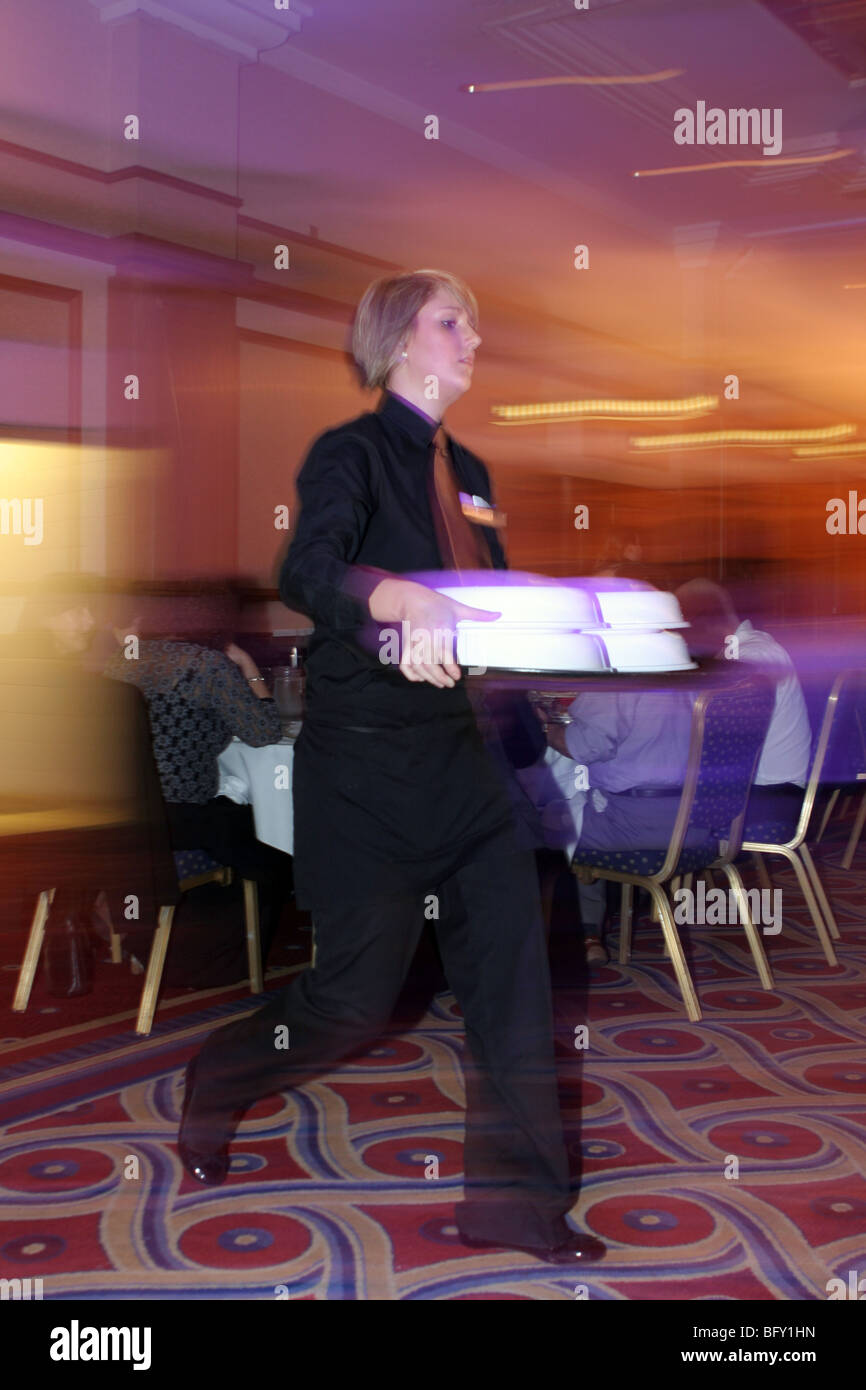Waitress carrying plates at dinner function in England, UK Stock Photo ...