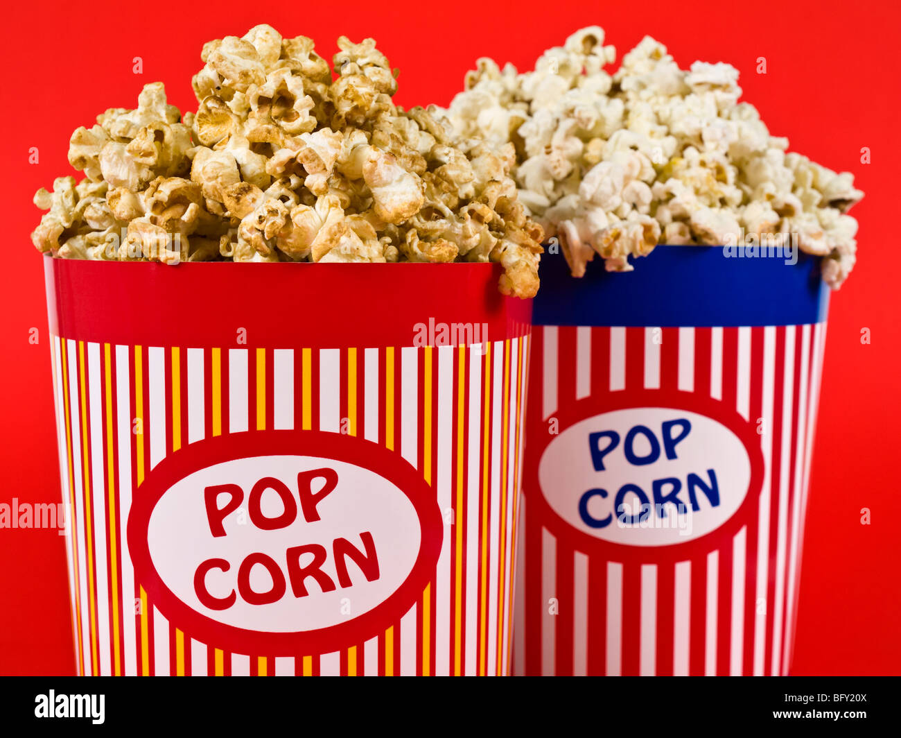 Two popcorn buckets over a red background Stock Photo - Alamy
