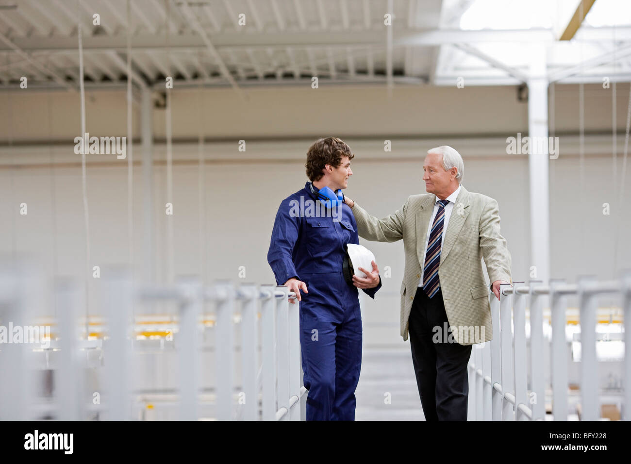 workman talking with boss Stock Photo - Alamy