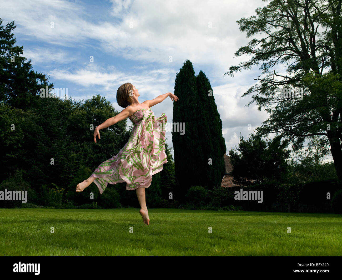 A young woman dancing in a garden Stock Photo - Alamy