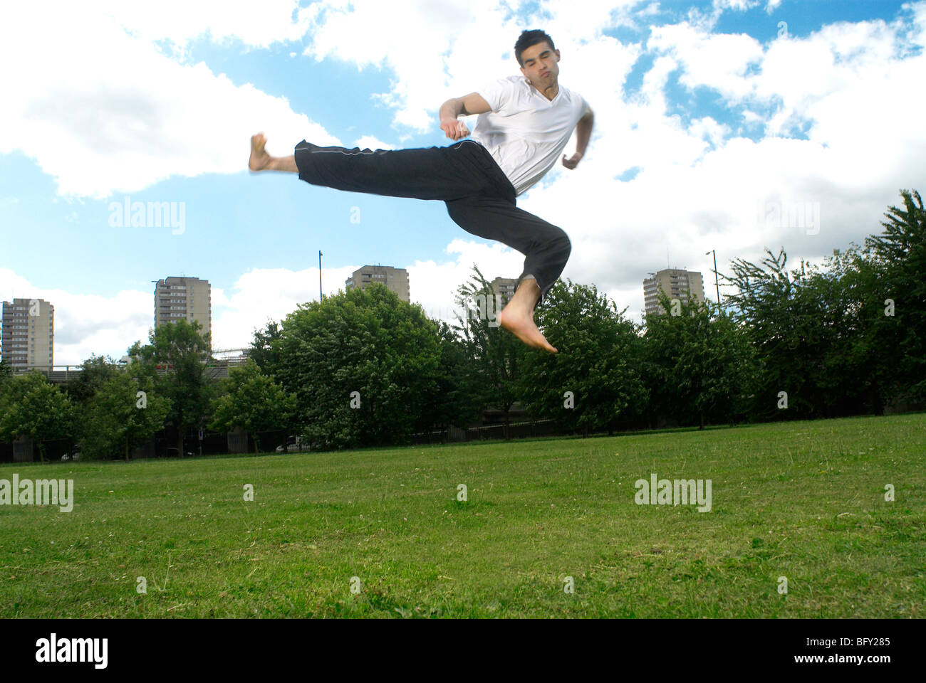 jumping kick in park Stock Photo - Alamy