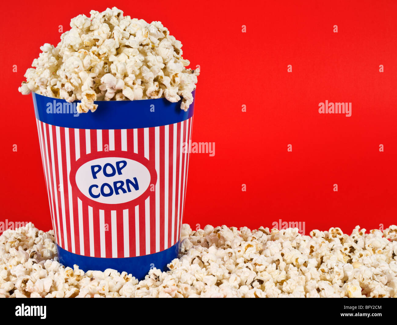 A popcorn bucket over a red background Stock Photo - Alamy