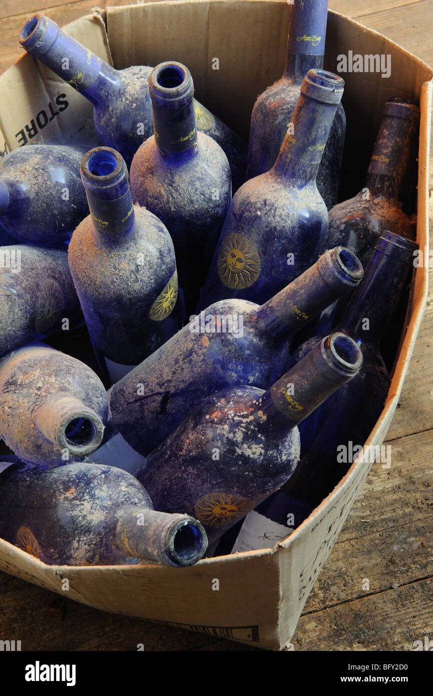 Dusty, empty blue wine bottles in an old cardboard box Stock Photo - Alamy