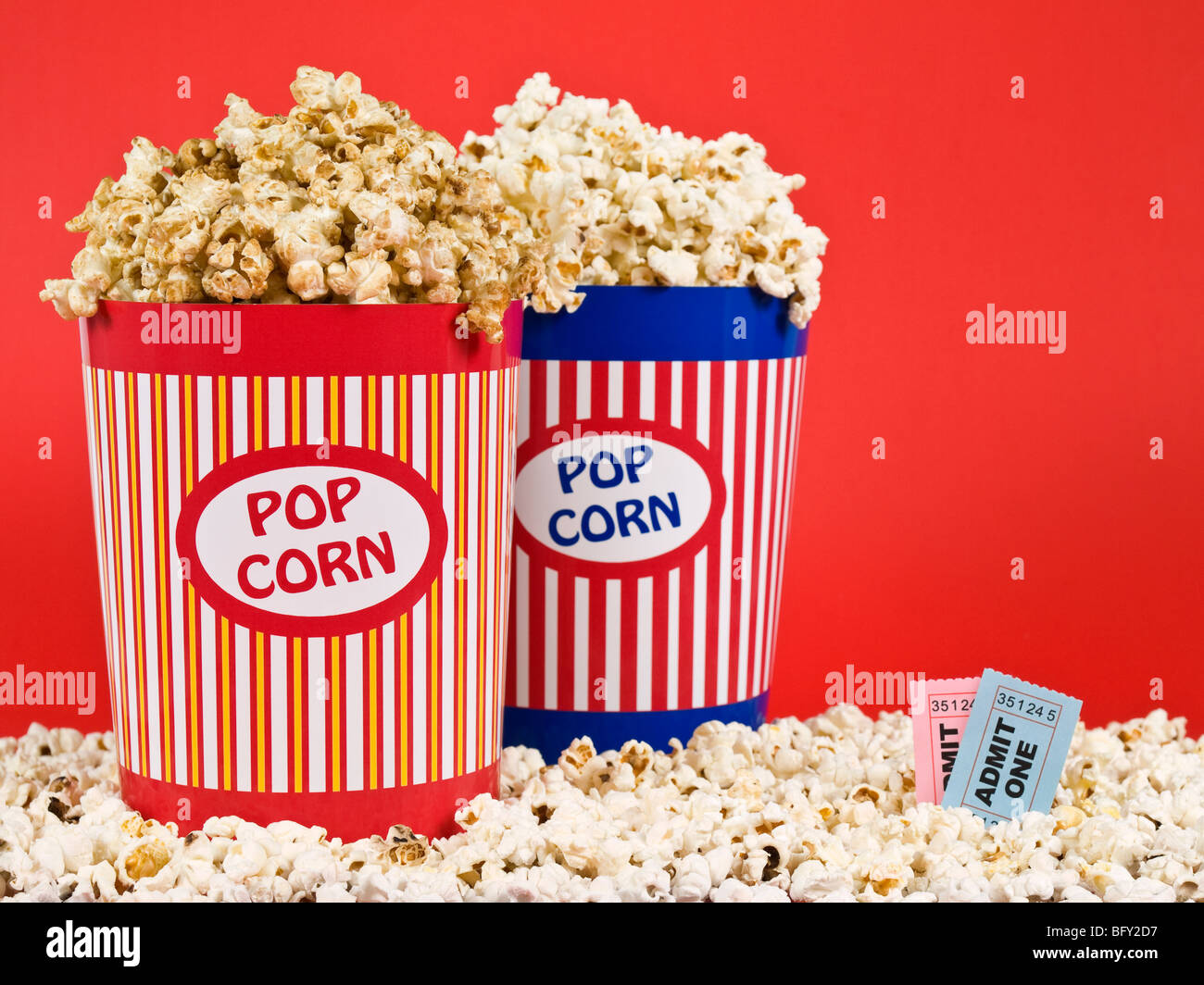 Two popcorn buckets over a red background Stock Photo - Alamy