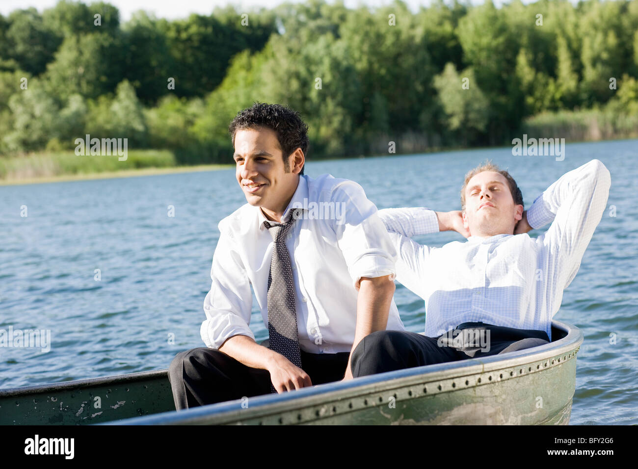 two businessmen relaxing in rowboat Stock Photo - Alamy
