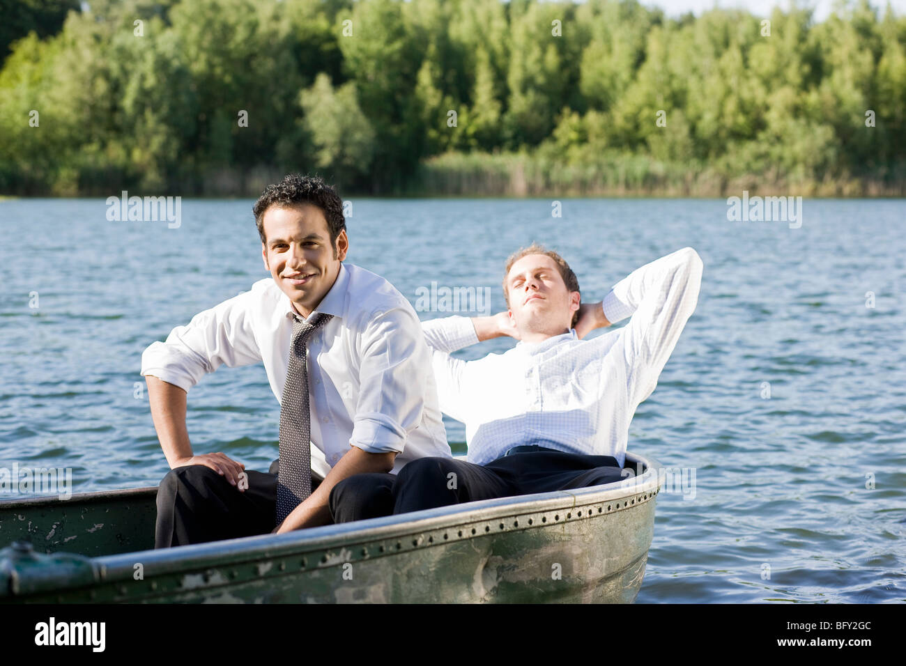 two businessmen relaxing in rowboat Stock Photo - Alamy