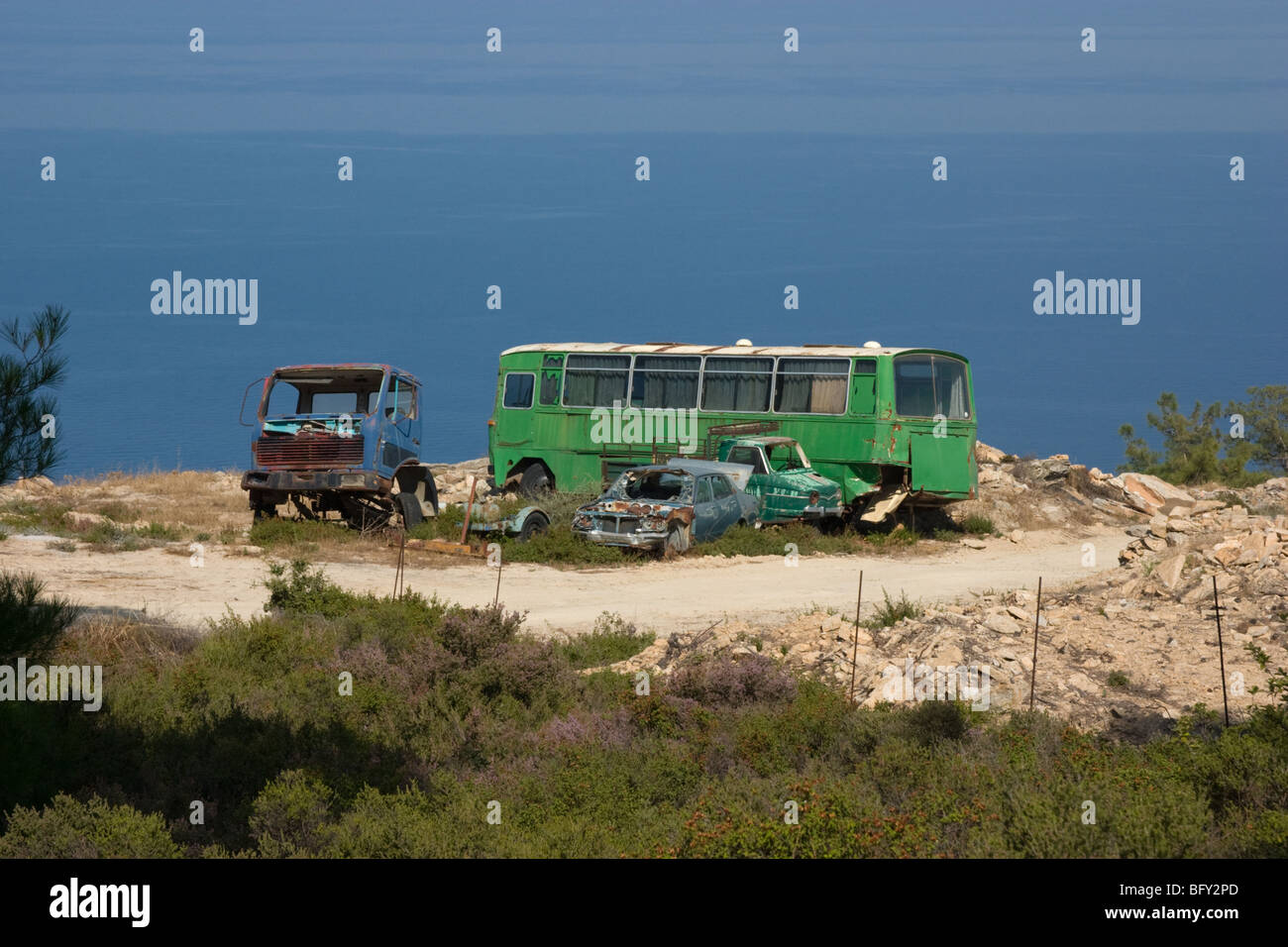 Old buses and cars dumped in the beautiful mountains on a Greek island ...