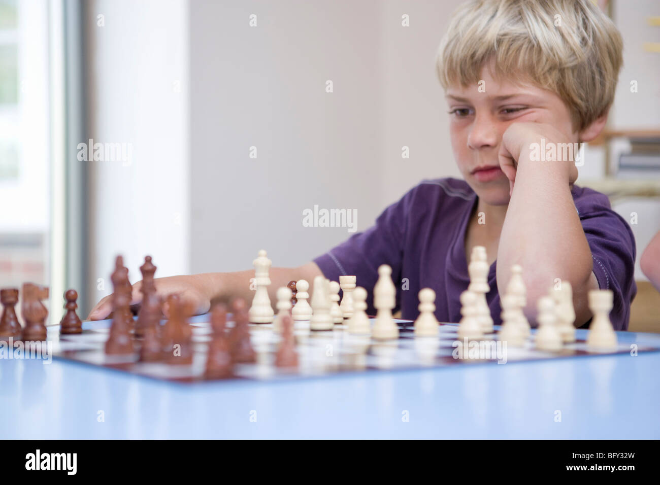 Boy playing chess Stock Photo - Alamy