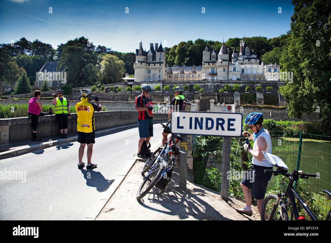Cyclist take a rest by the River Indre and the Chateau Usse in the ...