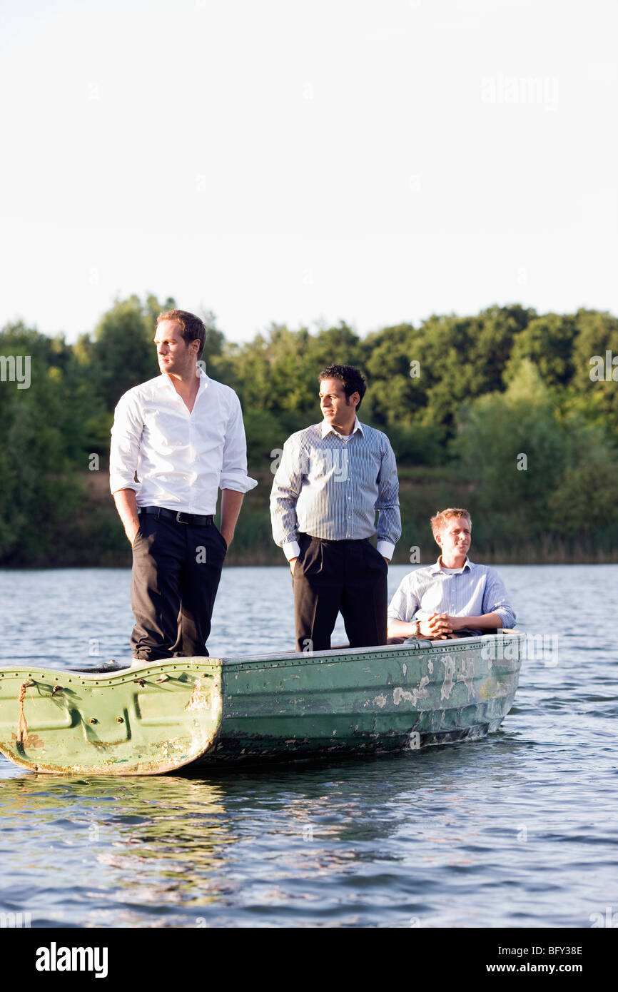 three businessmen in rowboat Stock Photo - Alamy