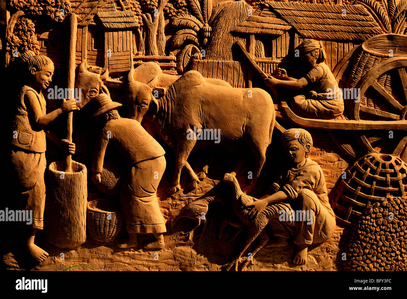 Stone carving of many people working with animals , Pattaya , Thailand ...