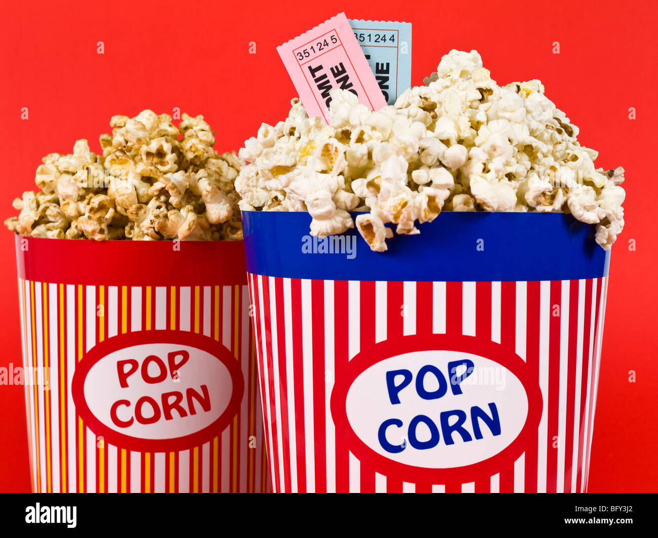 Two popcorn buckets over a red background. Movie stubs sitting over the ...