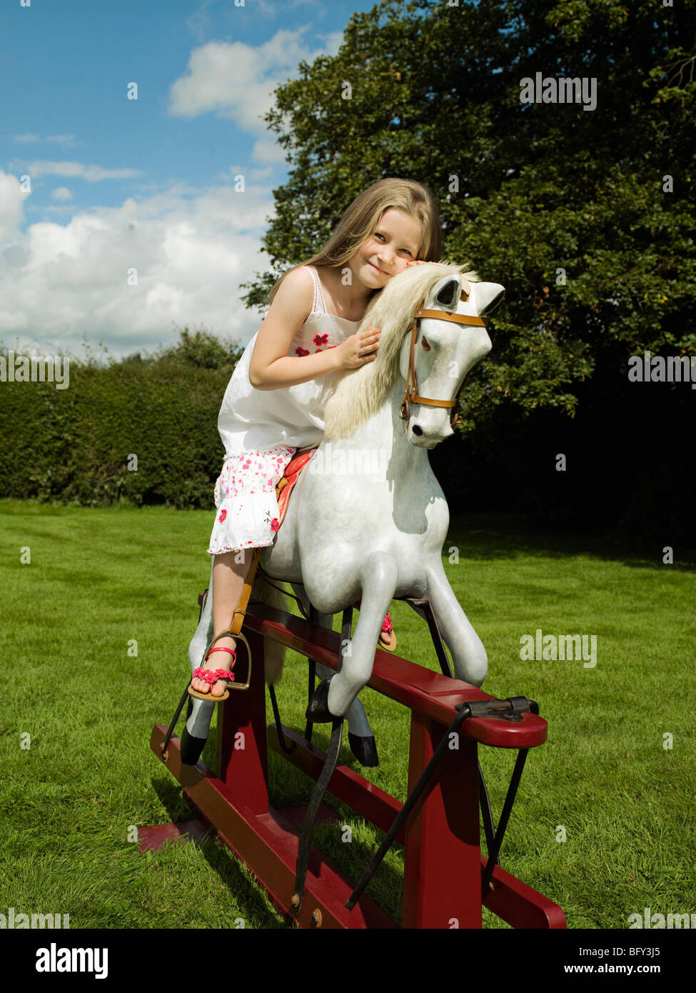 A young girl on a rocking horse Stock Photo - Alamy