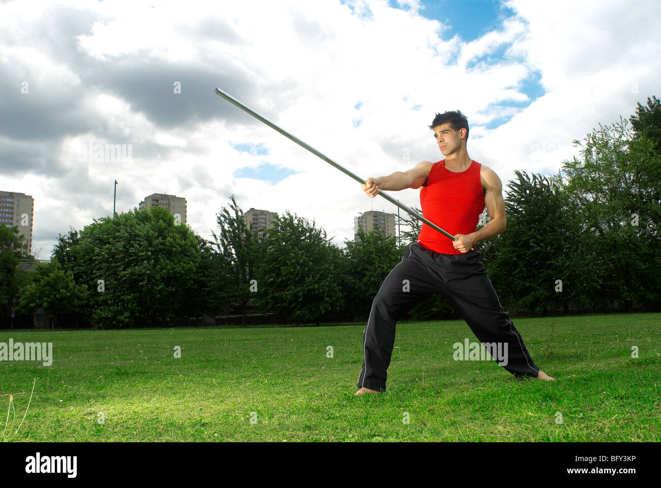 man posing with bow staff Stock Photo - Alamy