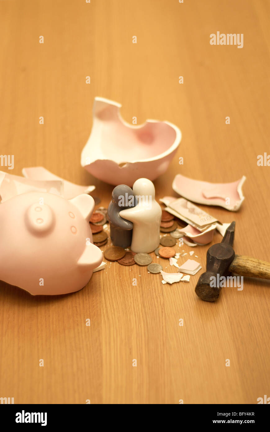 small figures and smashed piggy bank Stock Photo - Alamy