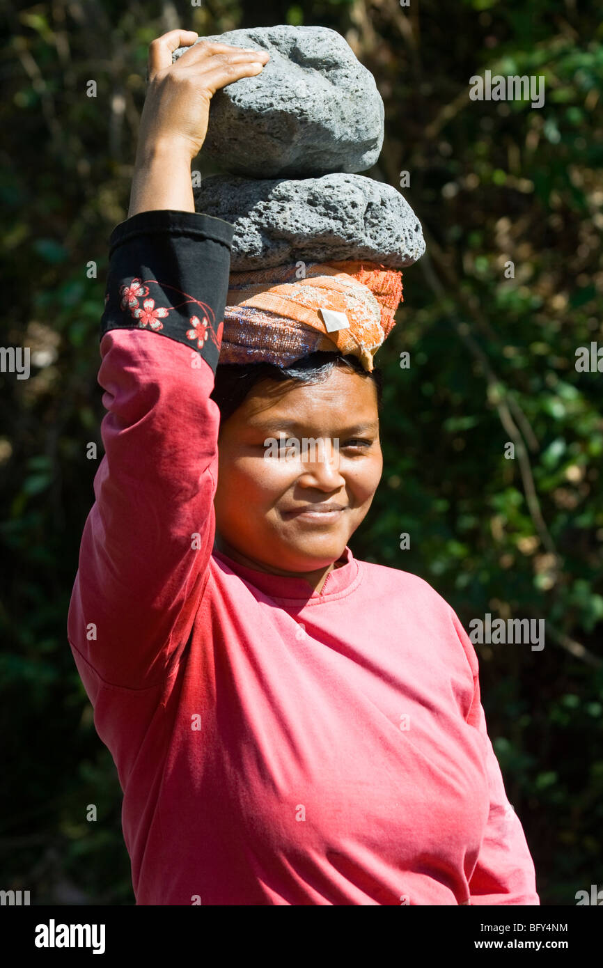 Woman carrying heavy stones on Lombok Island in Indonesia Stock Photo ...