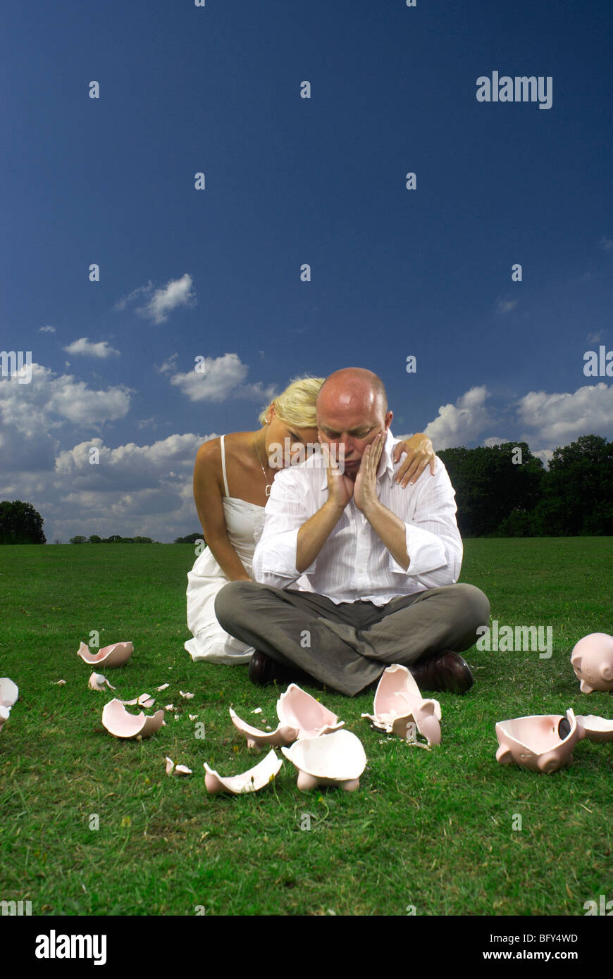 couple and smashed piggy banks Stock Photo - Alamy