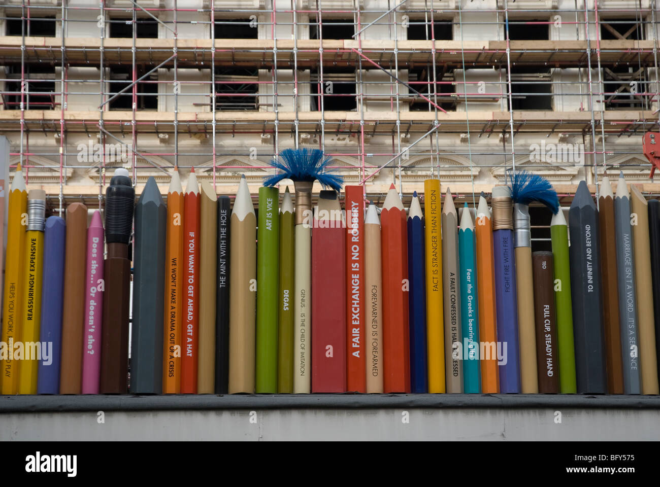 Decorative hoardings with pictures of coloured pencils on a building ...