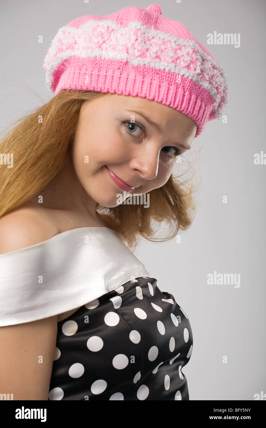 beautiful girl in pink beret and in black-and-white dress with ...