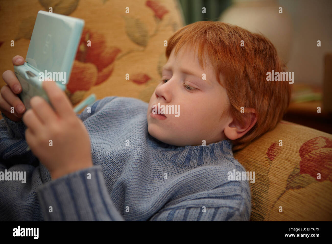 Young Boy playing Nintendo DS Stock Photo - Alamy