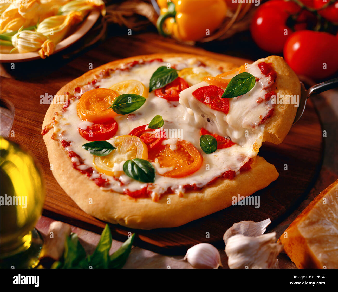 Heirloom tomato cheese pizza with piece pulling out Stock Photo - Alamy