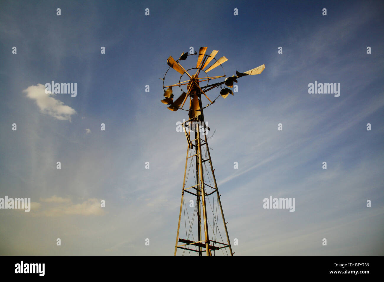 Windmill with blue sky behind Stock Photo - Alamy