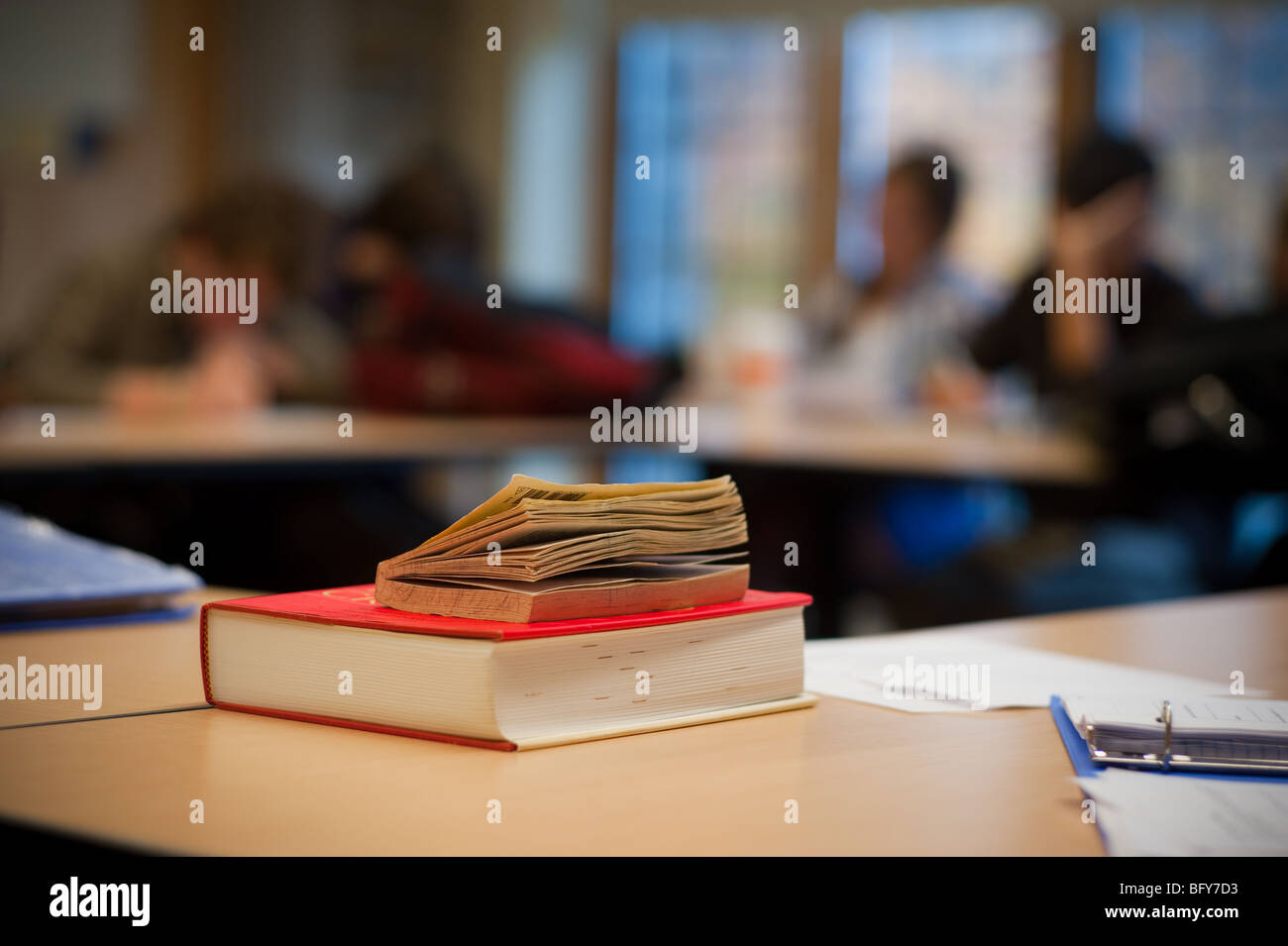books on table in school classroom Stock Photo - Alamy