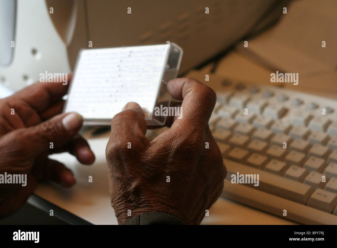 An old man trying to read some instruction on a case Stock Photo - Alamy