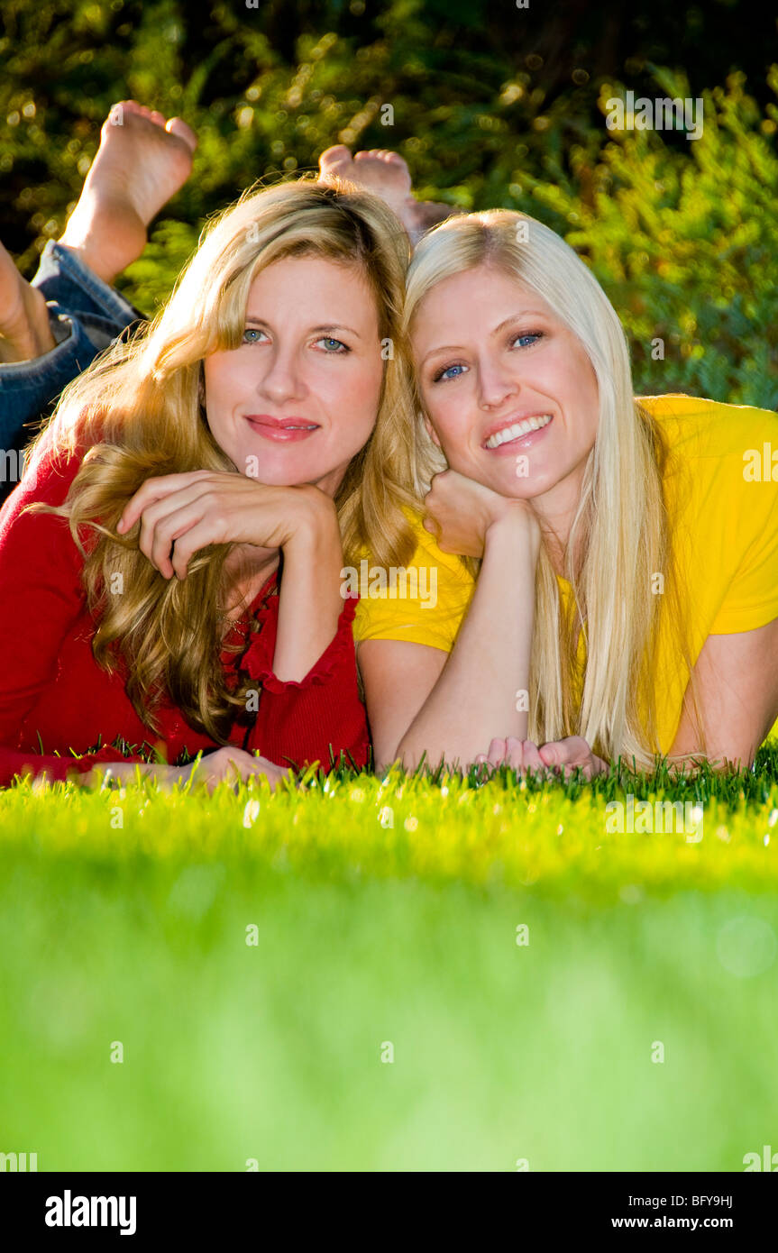 Women laying in grass Stock Photo - Alamy