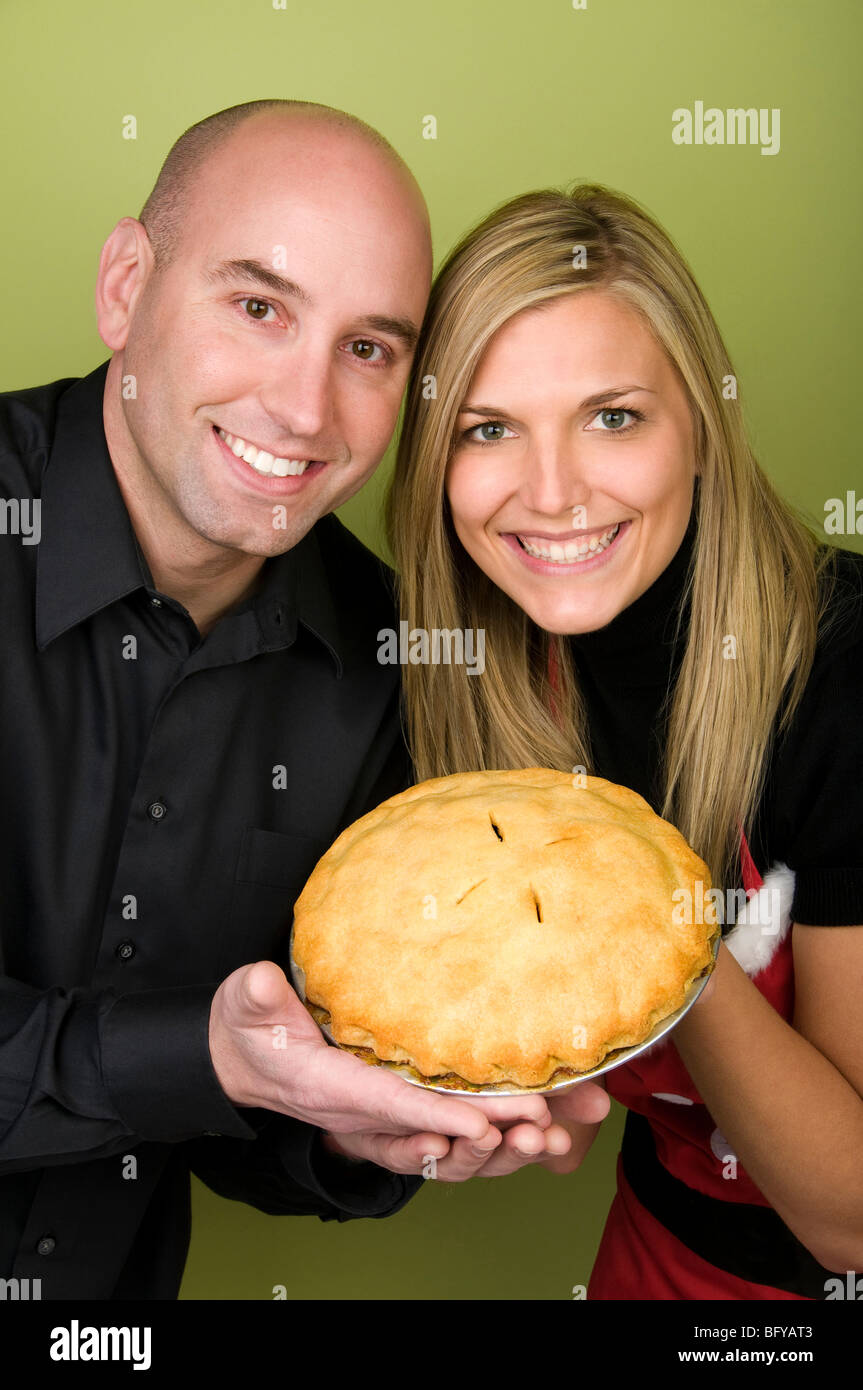 Couple holding pie Stock Photo - Alamy