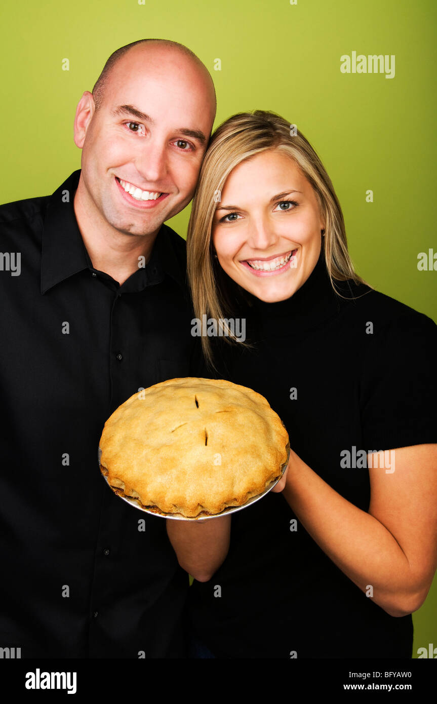 Couple holding pie Stock Photo - Alamy