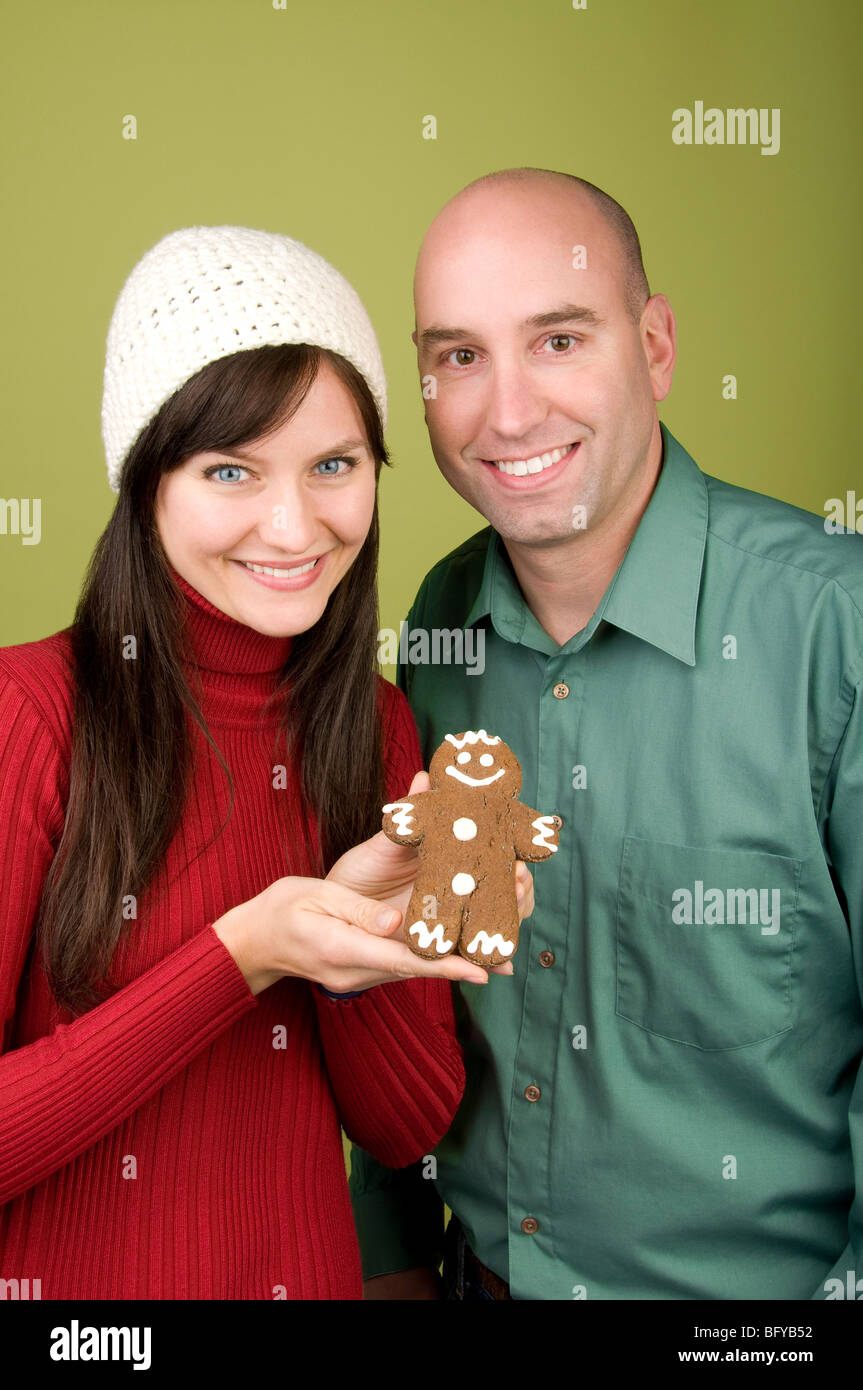 Couple holding gingerbread man Stock Photo - Alamy