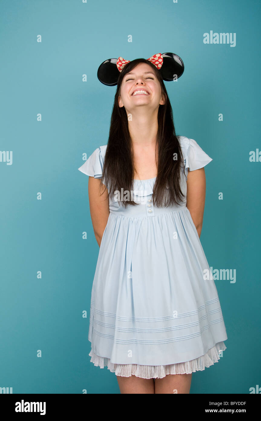 Woman wearing mouse ears and looking excited Stock Photo - Alamy