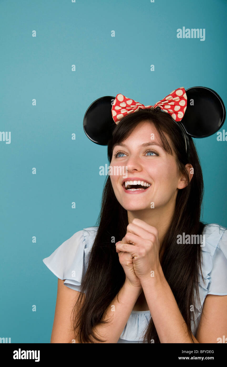 Woman wearing mouse ears and looking excited Stock Photo - Alamy