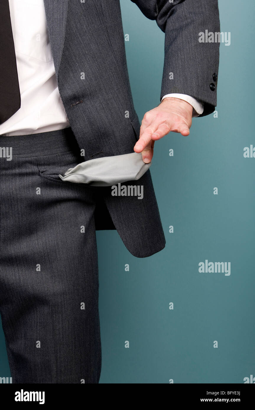 Businessman holding empty pocket Stock Photo - Alamy
