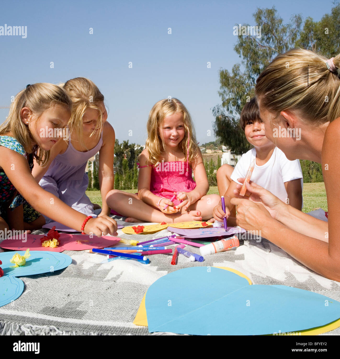 Teacher teaching students art & crafts Stock Photo - Alamy