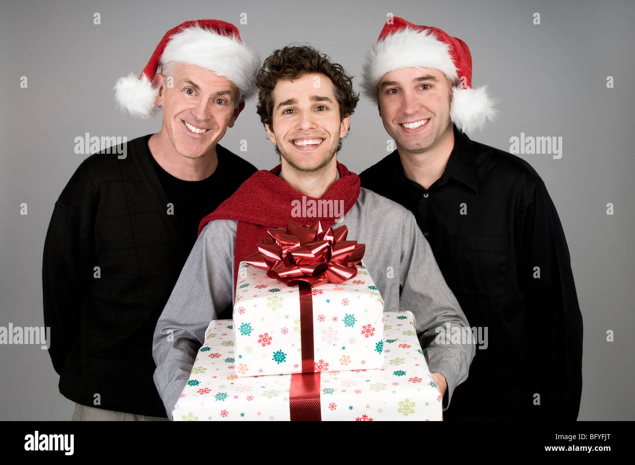 Men in santa hats holding hi-res stock photography and images - Alamy