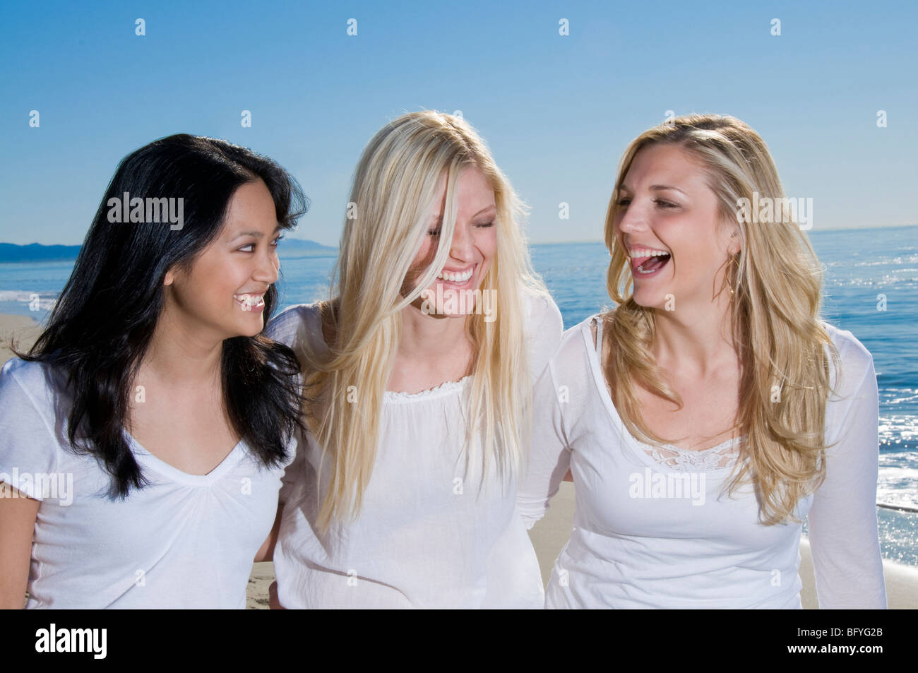 Women smiling on beach Stock Photo - Alamy