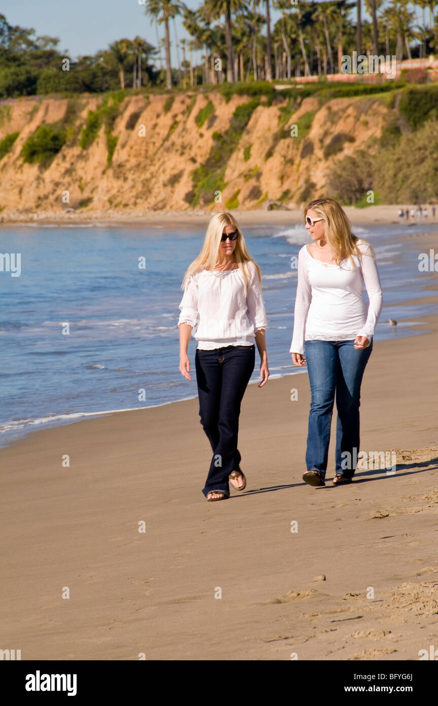 Women laughing on beach Stock Photo - Alamy