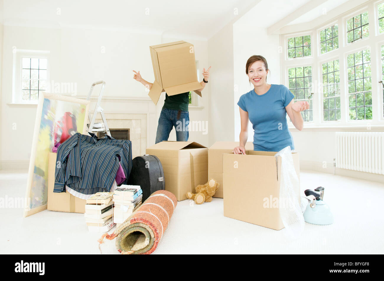 A couple having fun moving home Stock Photo - Alamy
